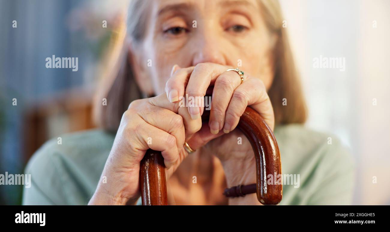 Walking stick, thinking and senior woman with disability in home, arthritis and depressed in ...