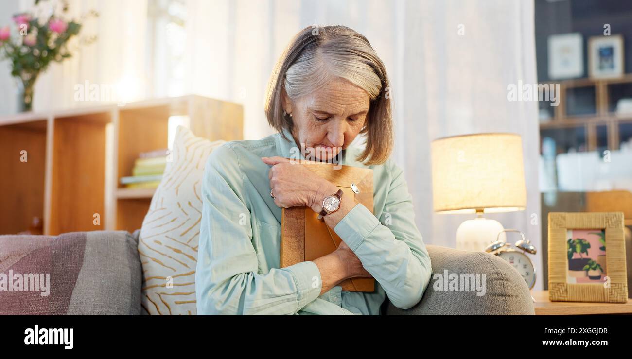 Senior woman, picture and sad with grief for mourning, memory and remember past life in nursing ...
