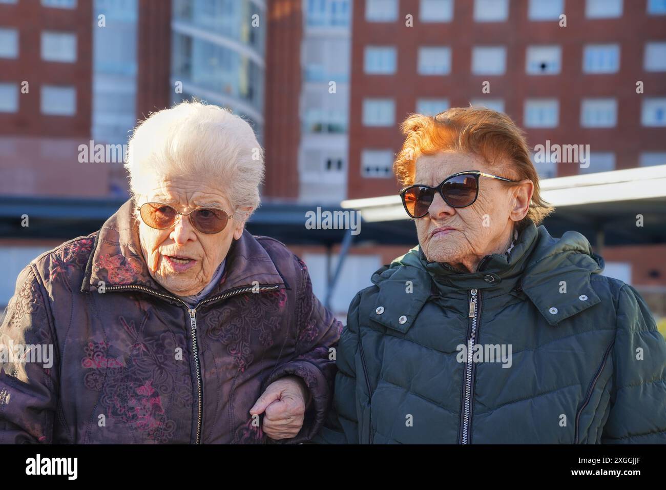 Two older sisters in sunglasses talking outside. Family time Stock ...