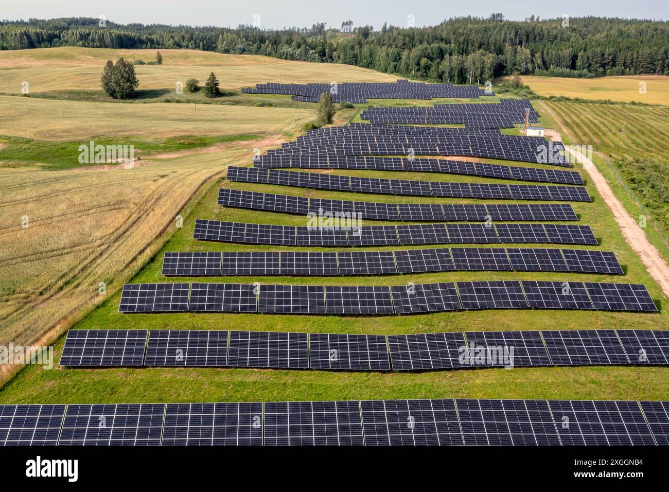 A large solar farm installed on a grassy hillside Stock Photo - Alamy