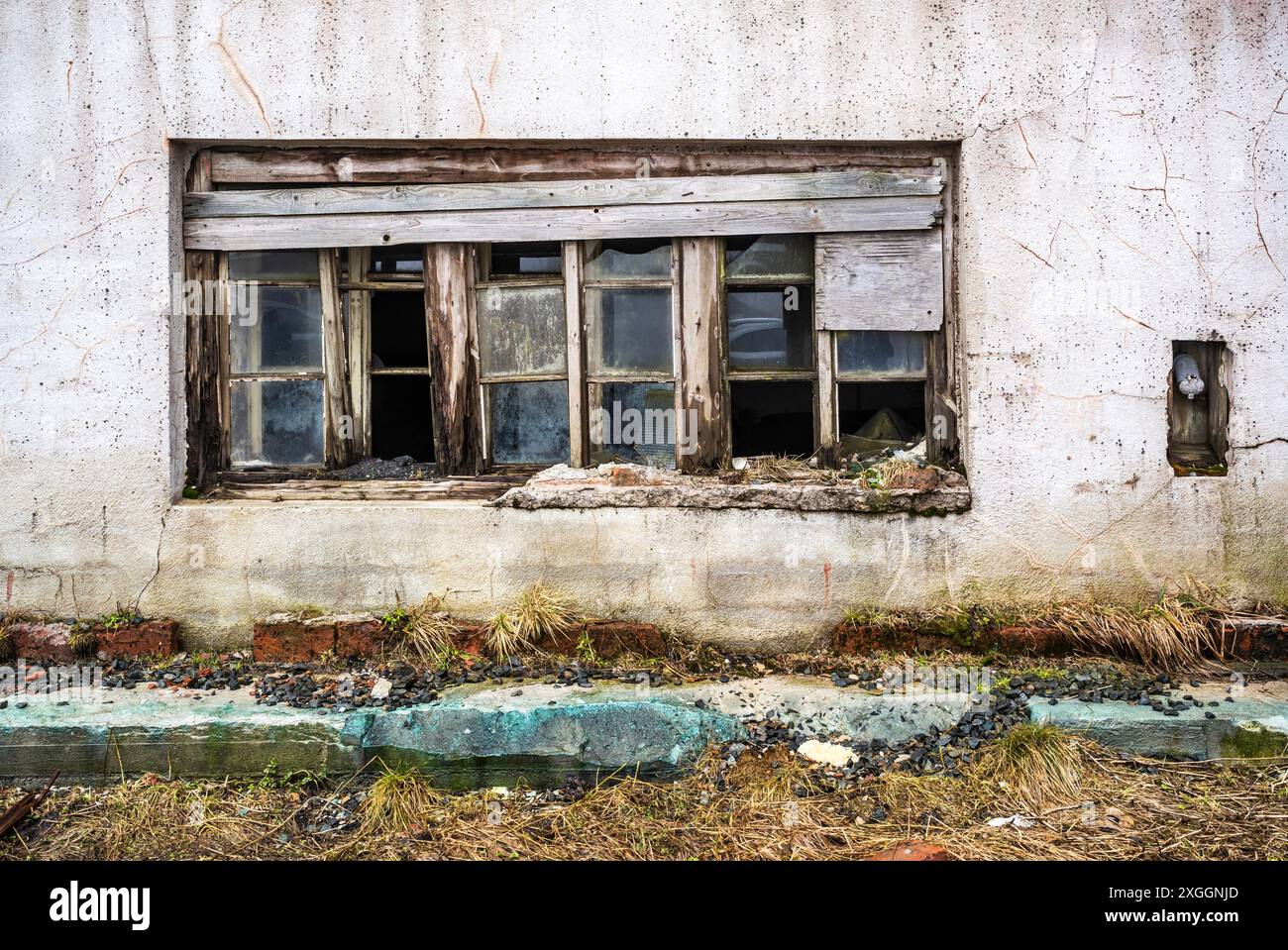 Dirty destroyed window on old building. Devastation. Ore mountain, hill ...