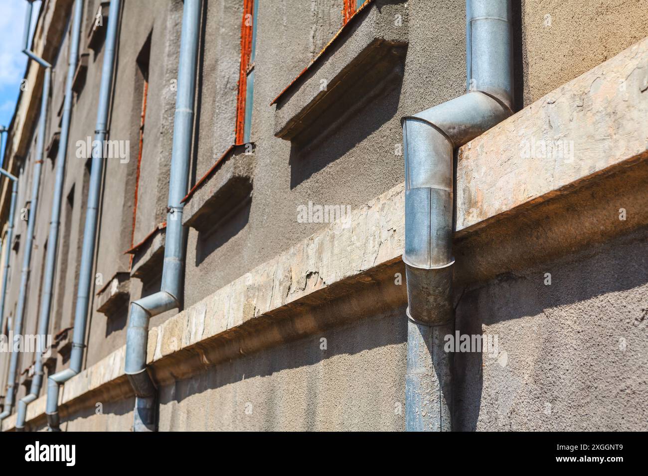 Building exterior with a lot of rain pipes and windows. Old wall with storm pipes Stock Photo ...