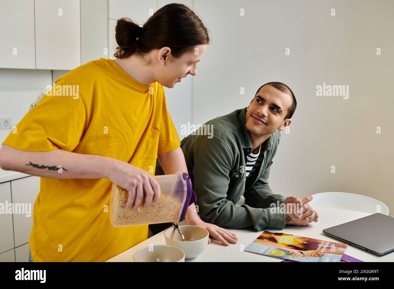 A young gay couple enjoys a casual morning together in their modern ...