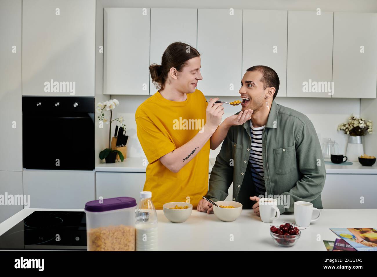 A young gay couple shares a lighthearted moment in their modern ...