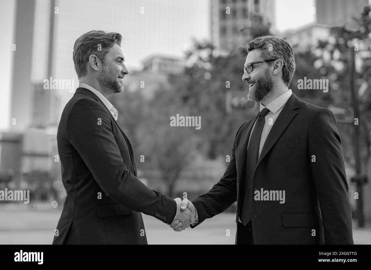 Business handshake outside in city Black and White Stock Photos ...