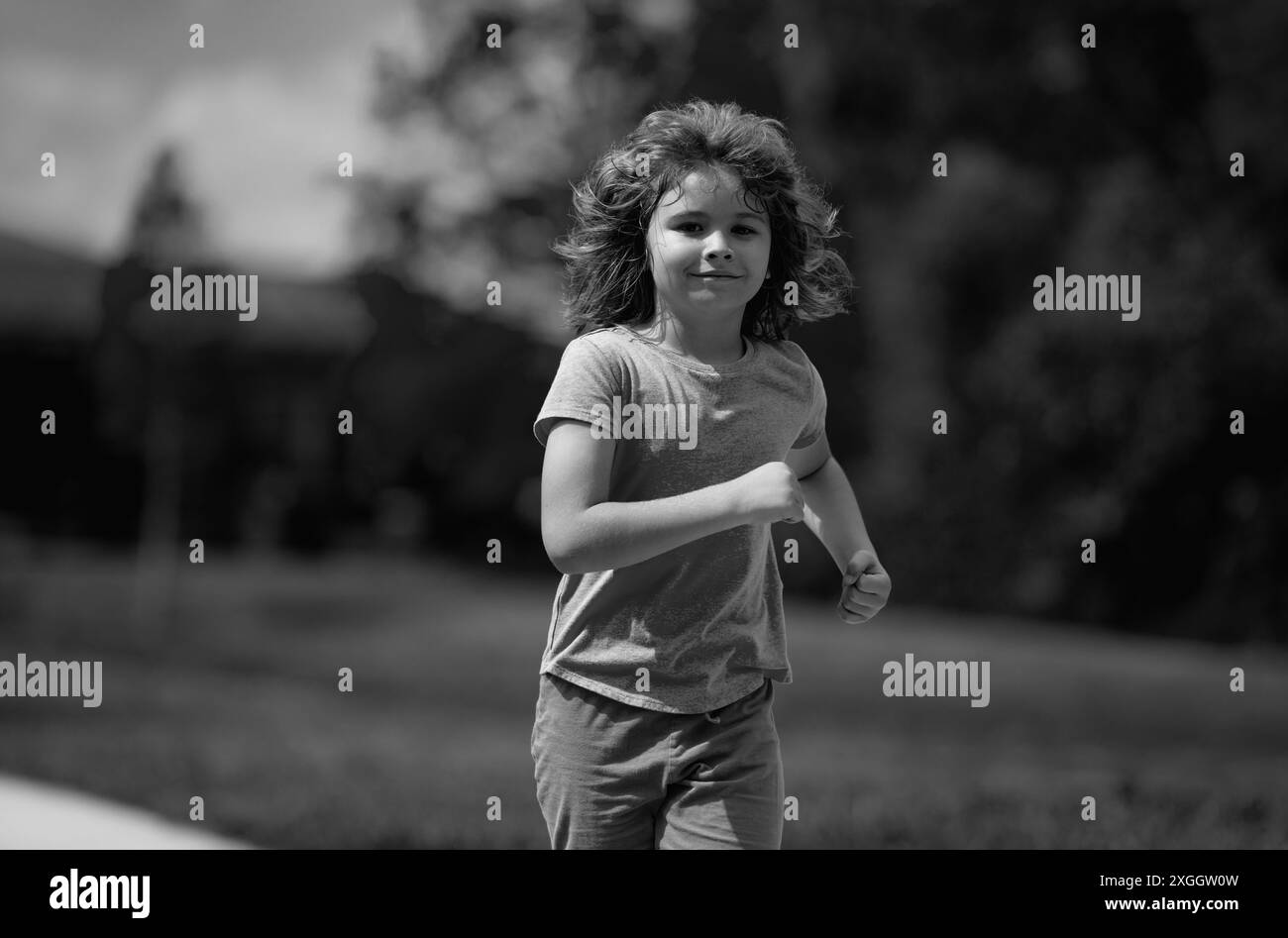Cute kid boy running across american neighborhood street. Summer ...