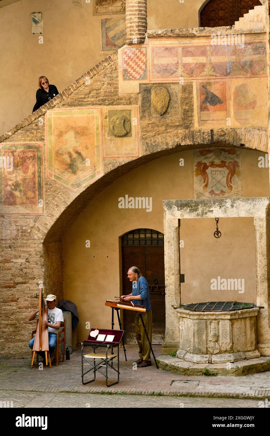 San Gimignano in Tuscany, Italy, musicians playing historic instruments ...
