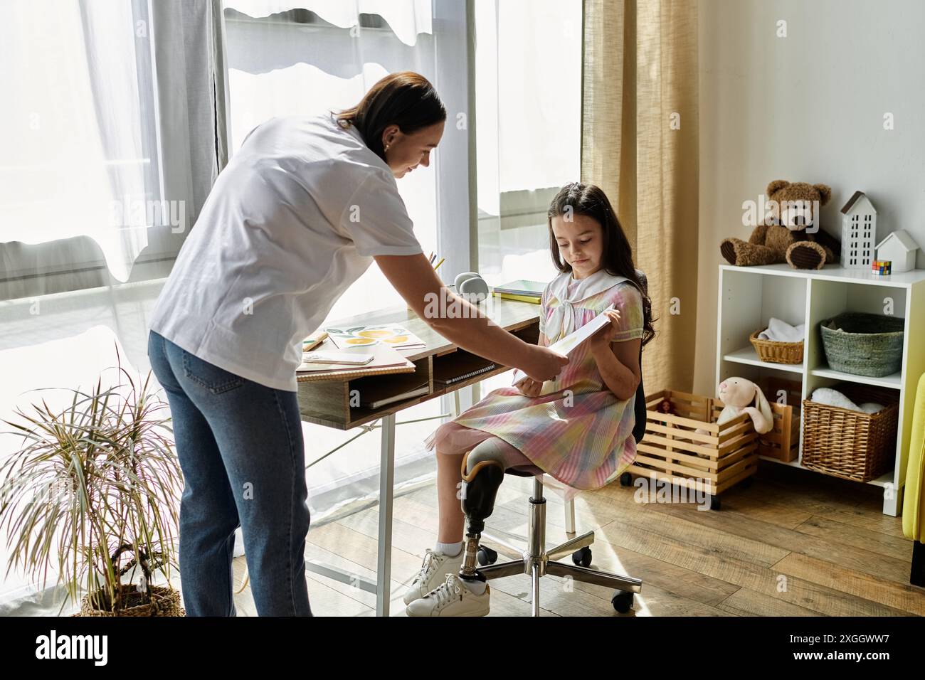 A Brunette Mother Helps Her Daughter With A Book At Their Home Desk