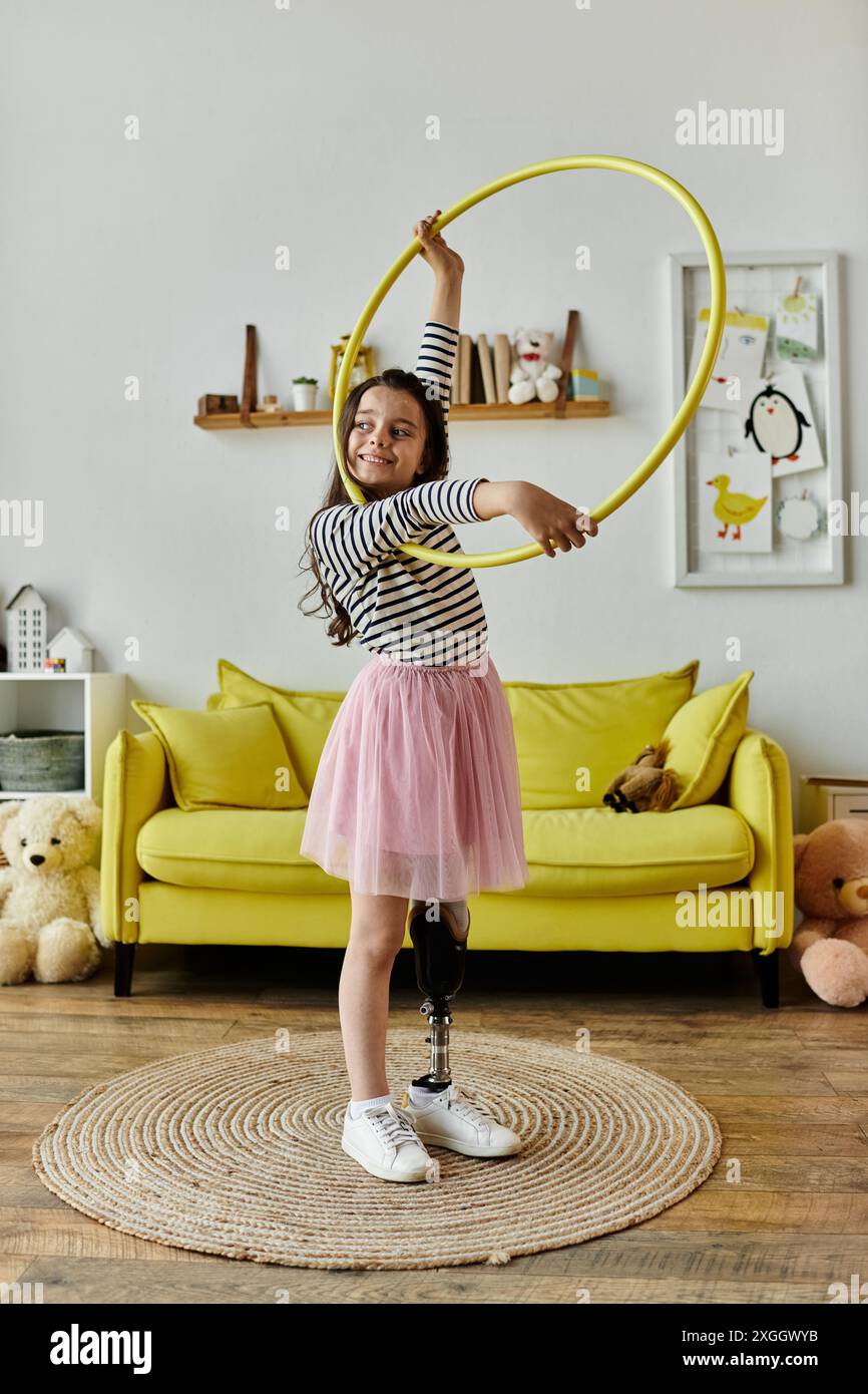 A young girl with a prosthetic leg smiles as she plays with a hula hoop ...