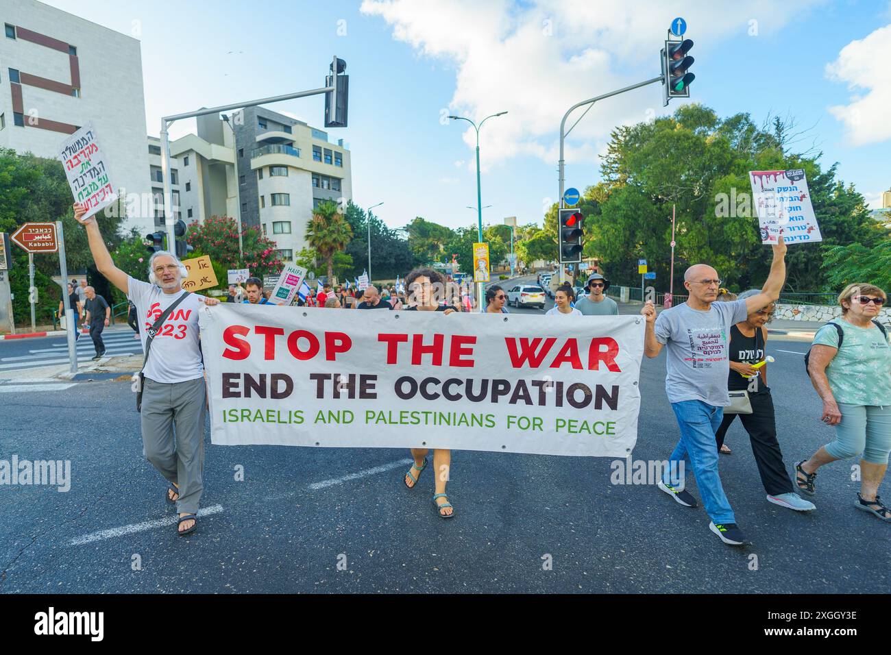 Haifa, Israel - July 06, 2024: People with signs calling for peace talk ...