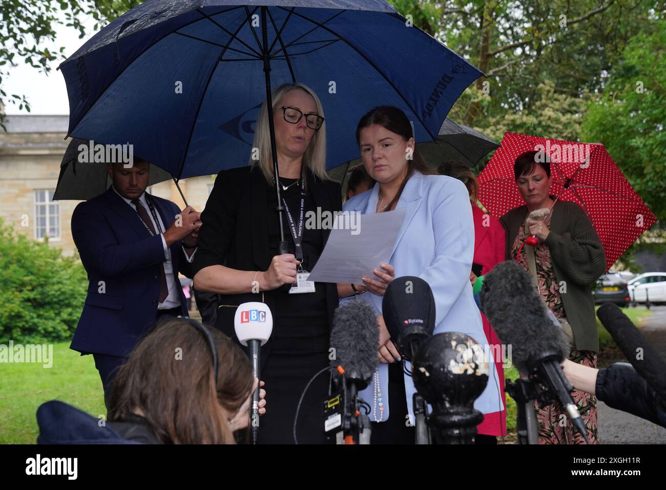 Detective Constable Natalie reads a statement to the media beside ...