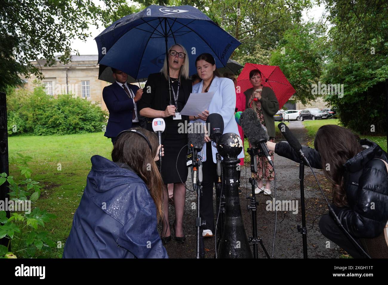Detective Constable Natalie reads a statement to the media beside ...