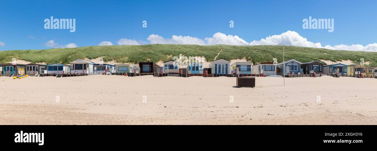 Panoramic view of beach huts with dunes in background at Egmond aan Zee ...