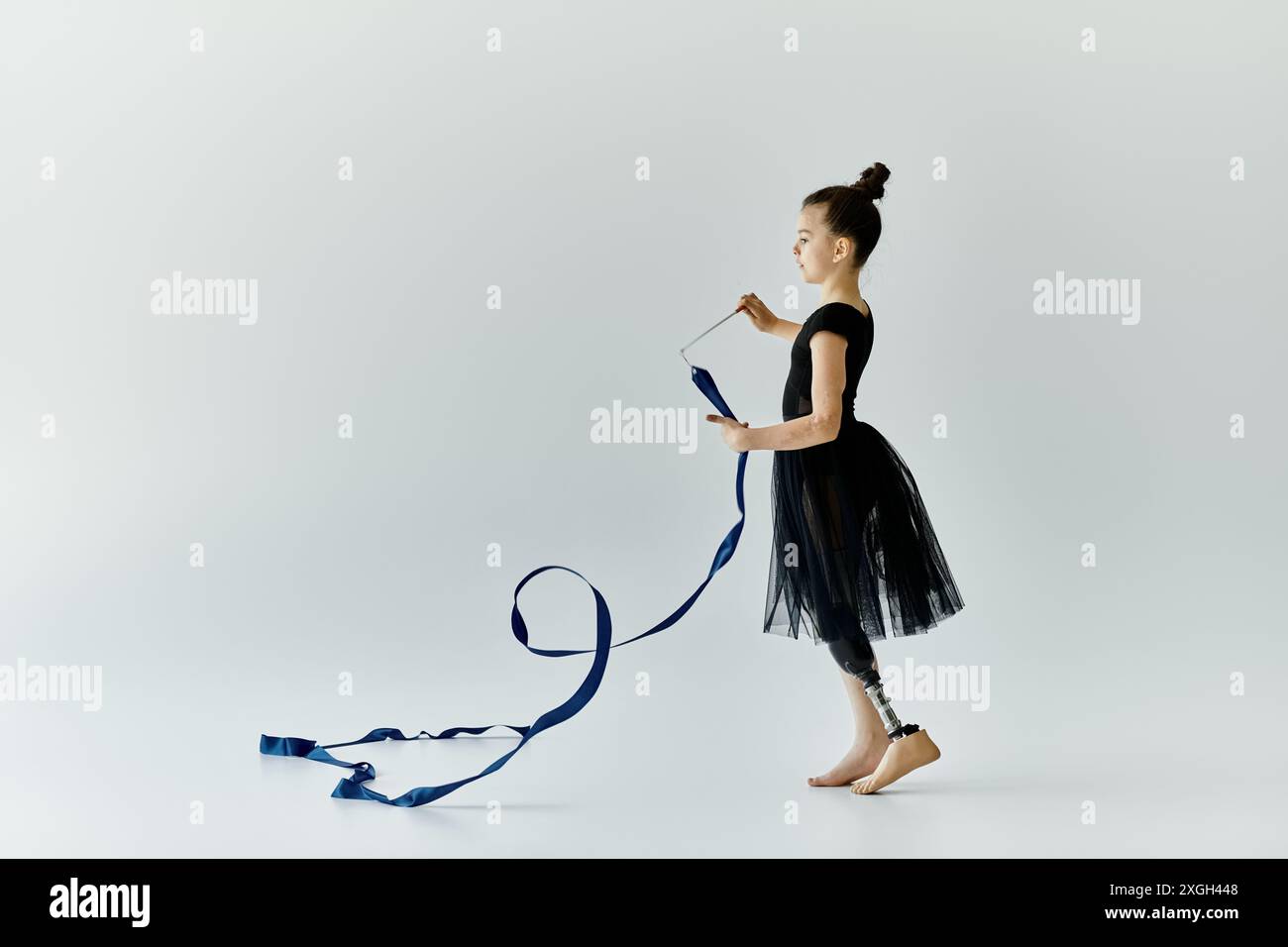 A young girl with a prosthetic leg performs a graceful ribbon dance in ...