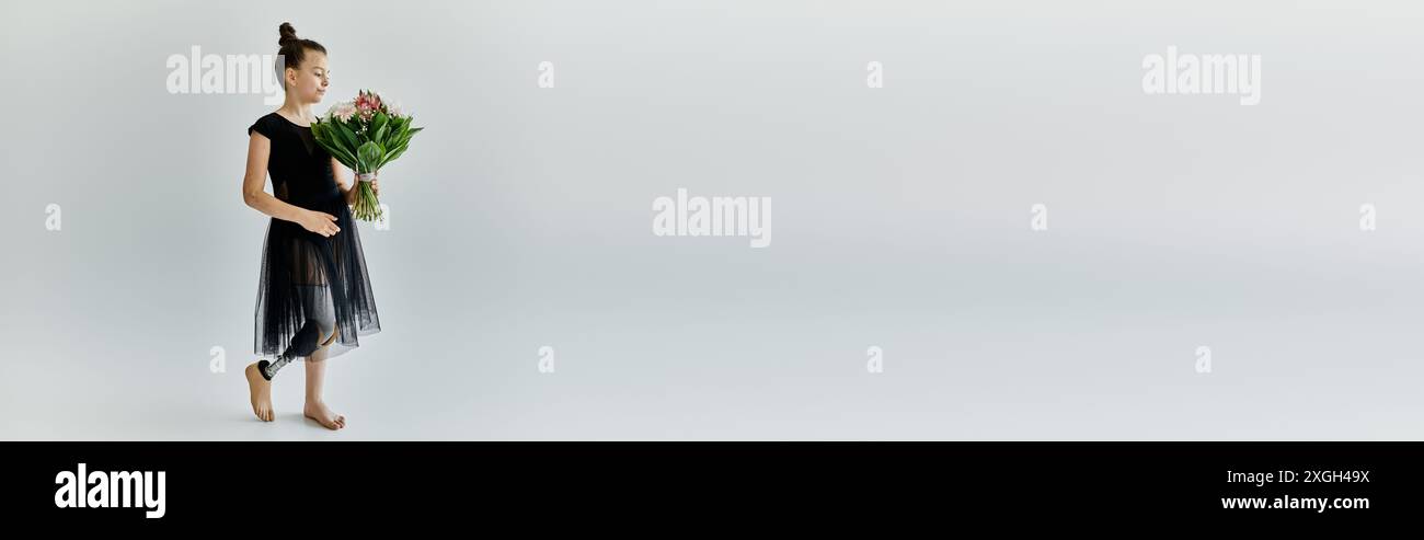 A young girl with a prosthetic leg walks gracefully while holding a ...