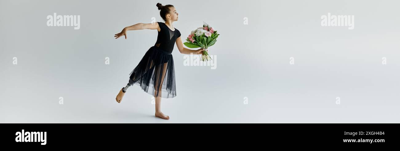 A young gymnast with a prosthetic leg performs a graceful pose while ...