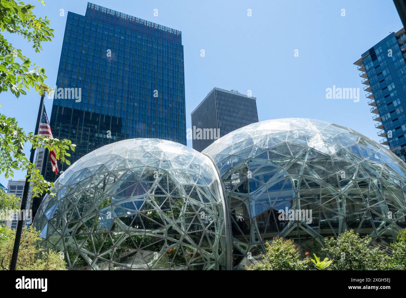 An American flag flies next to the Amazon Spheres and office towers at ...