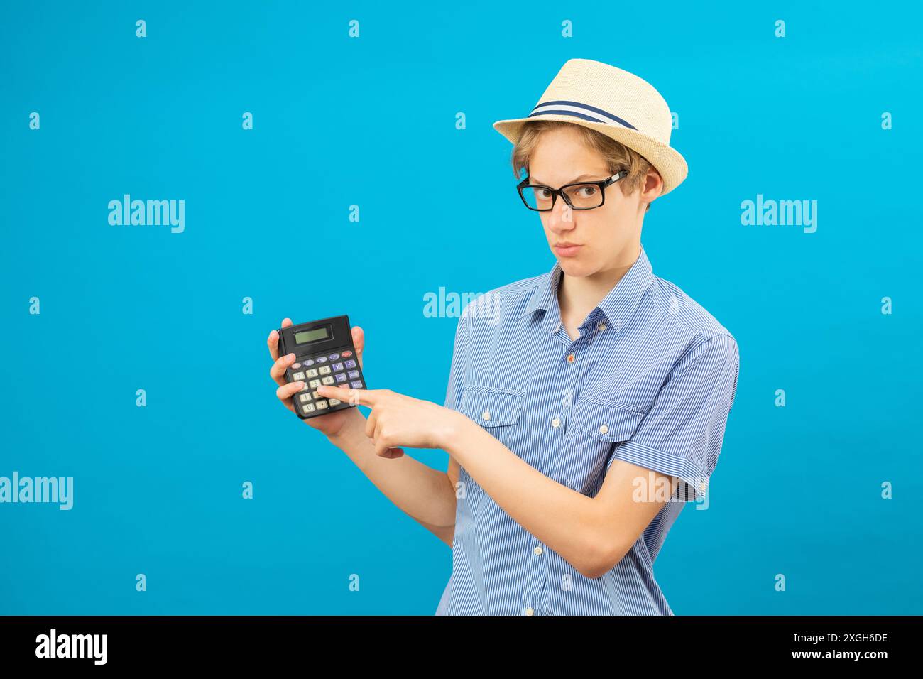 Surprised student holding calculator. Portrait of funny cute teen boy ...