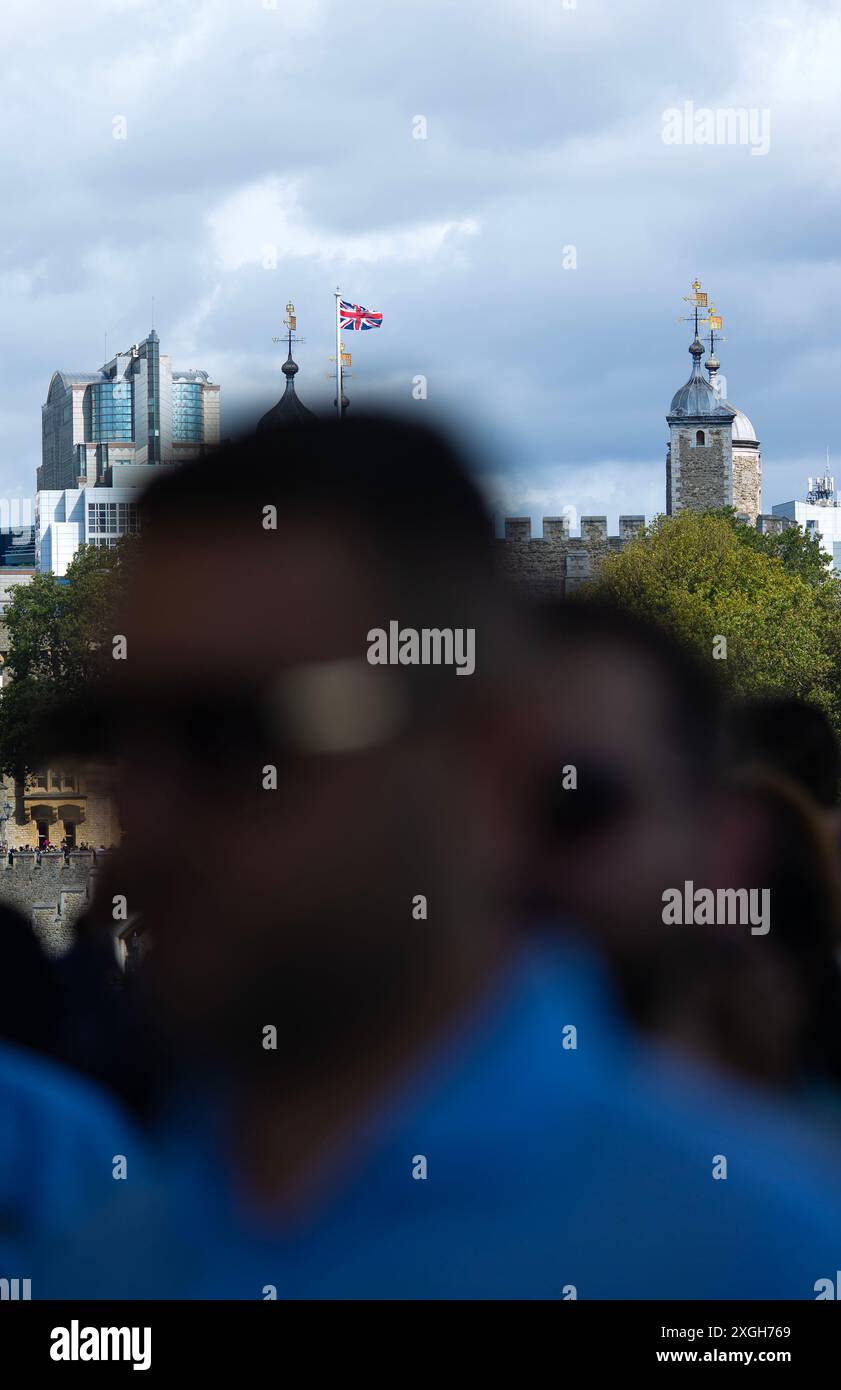 People walk on Tower Bridge in London as many tourists are expected to ...