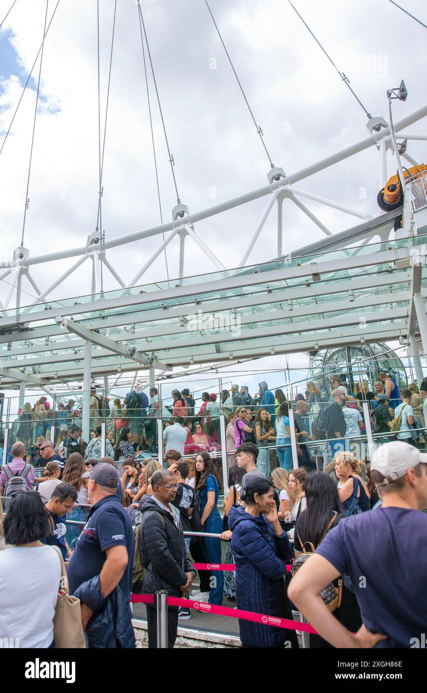 People queue to get on the London Eye in London as many tourists are ...