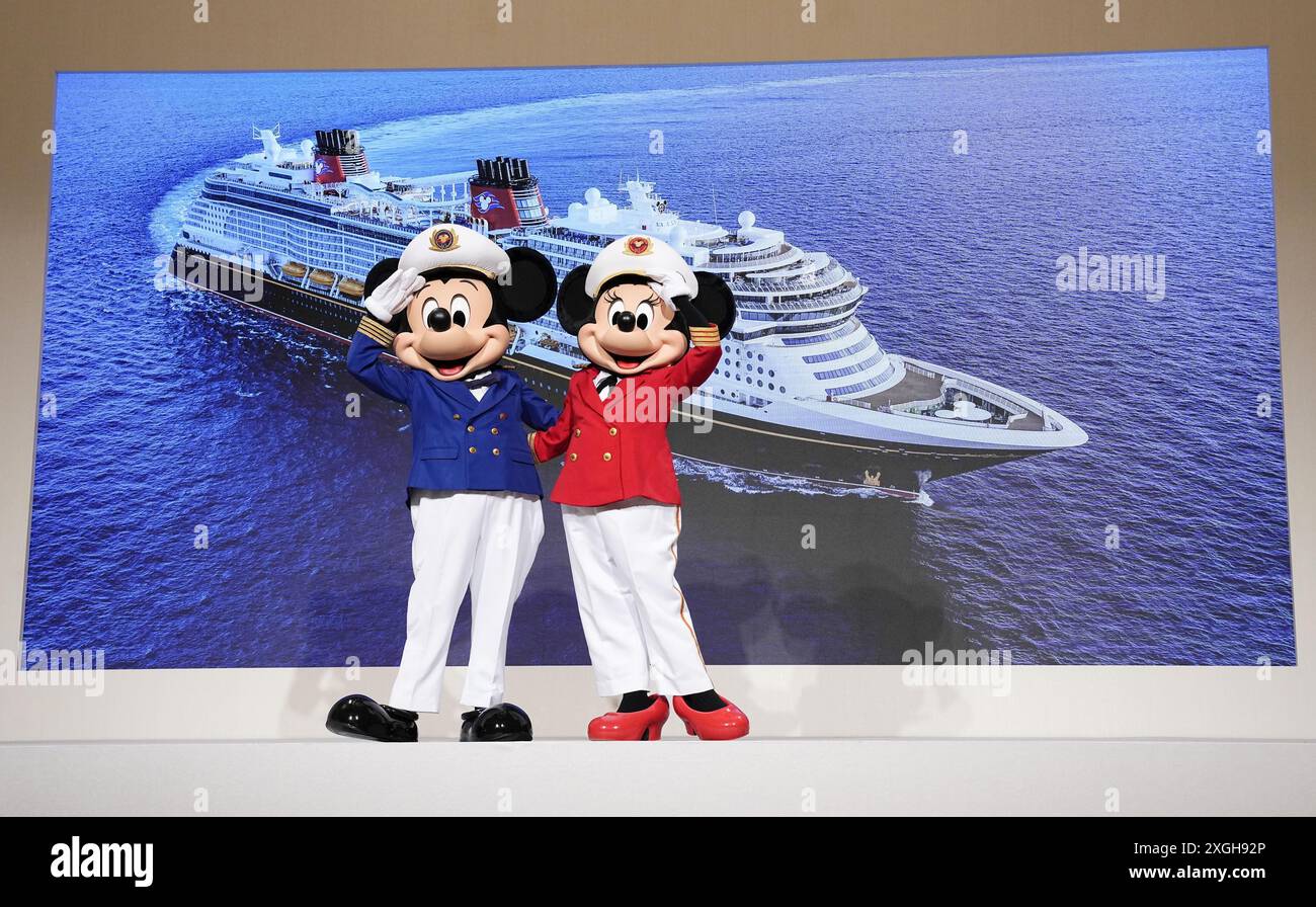 Mickey Mouse (L) and Minnie Mouse pose for photos during a press ...