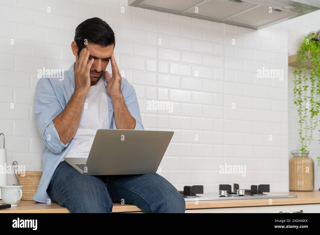 Attractive bearded young man use laptop computer to surfing social ...