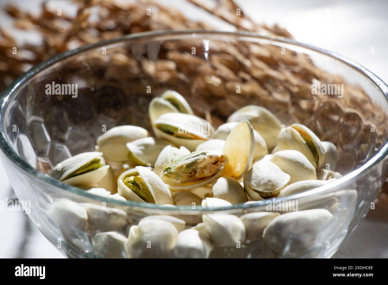 closeup Pistachio nuts in white glass bowl isolated on white background ...