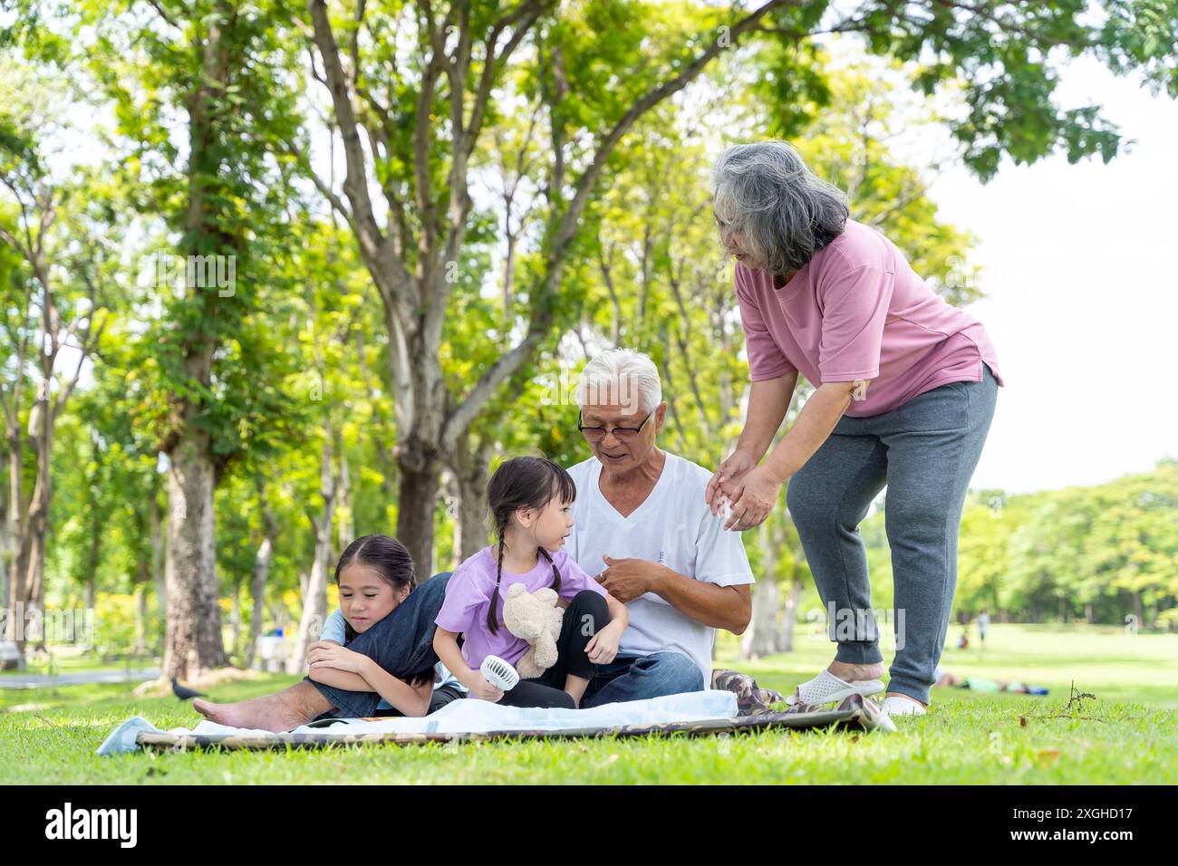 Grandparents having fun with their grandchildren in city park. Adorable ...
