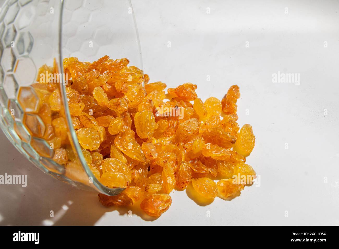 Yellow raisins in a glass bowl, isolated on white, negative space Stock ...