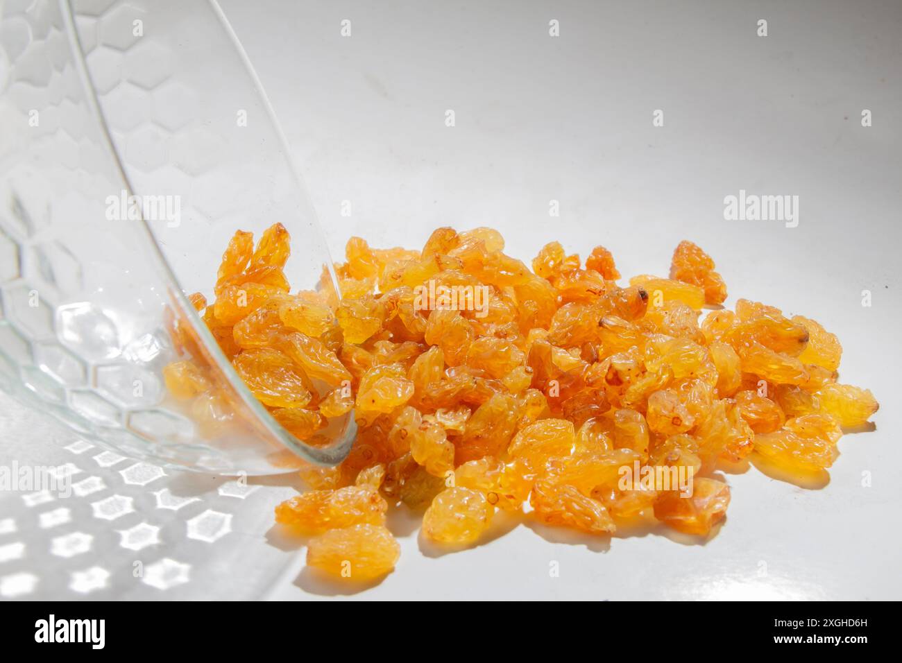 Front bottom view Yellow raisins in open glass bowl, isolated white ...