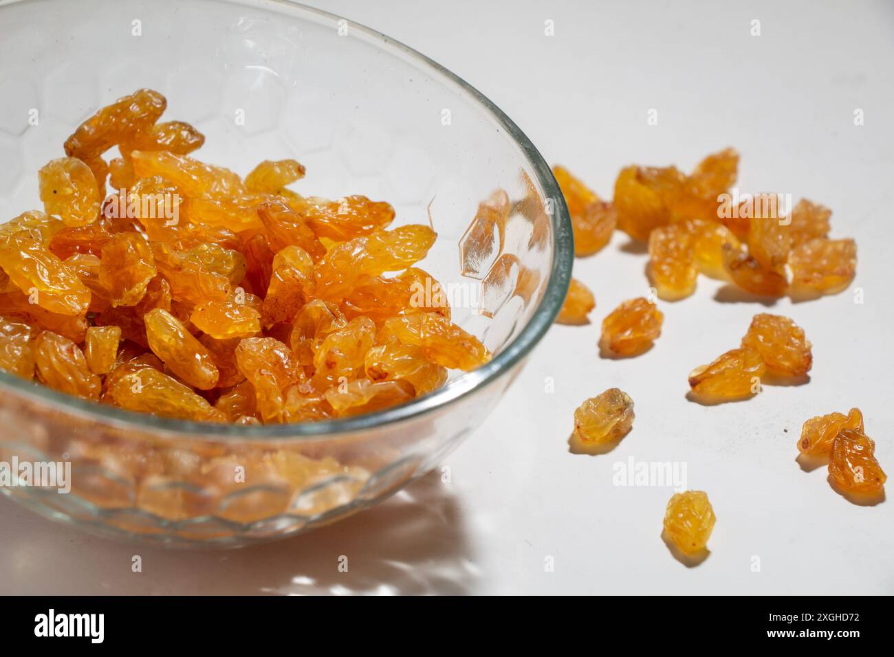 closeup Yellow raisins in open glass bowl, isolated on white Stock ...