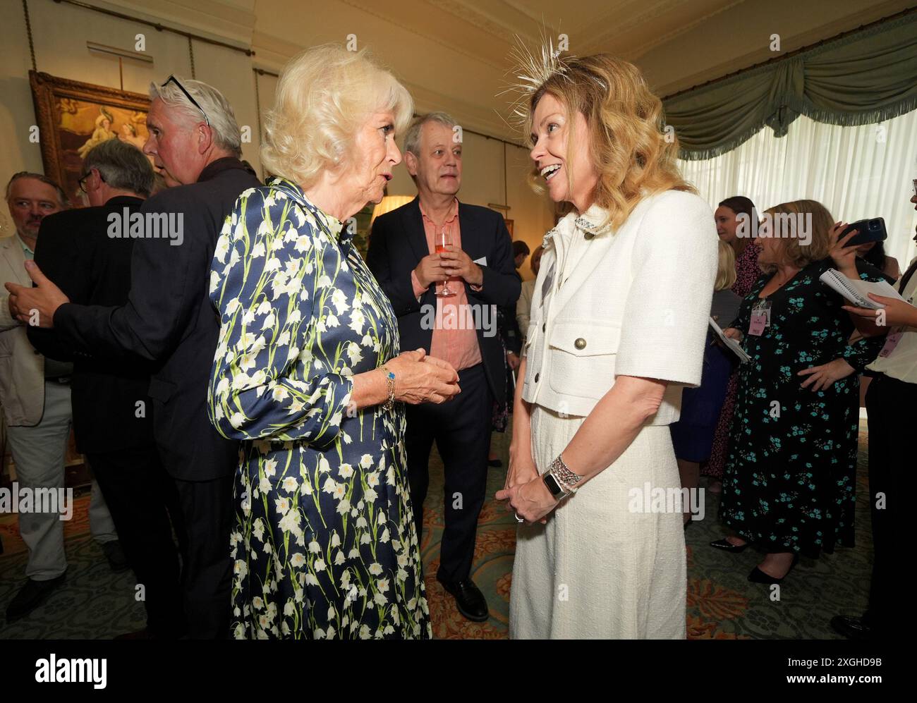 Queen Camilla meets with Adele Parks (right) as she hosts community ...