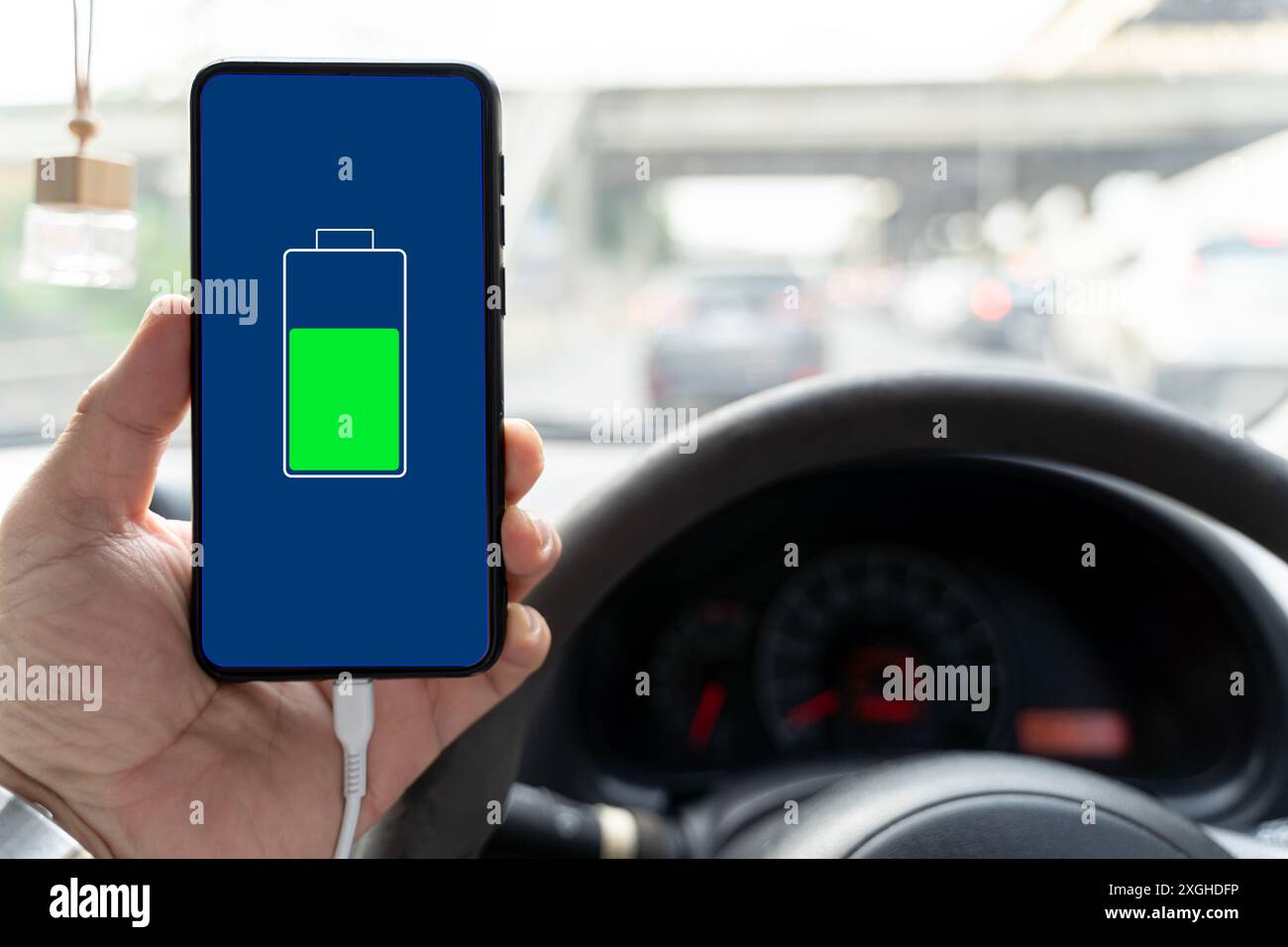 The phone is charging from the car. Mobile phone ,smartphone, cellphone ...