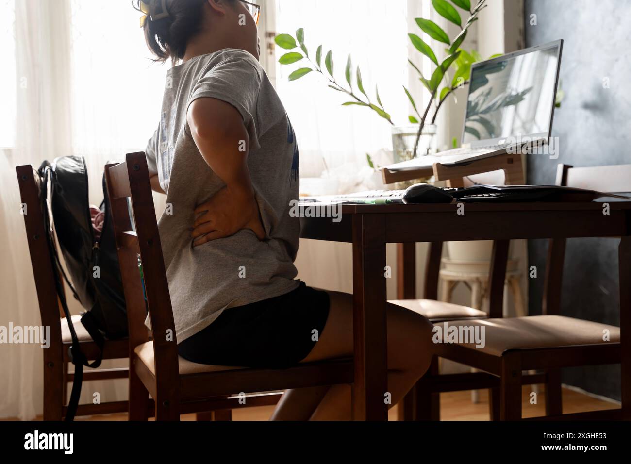 Working woman sitting on the chair in the living room at home She used ...