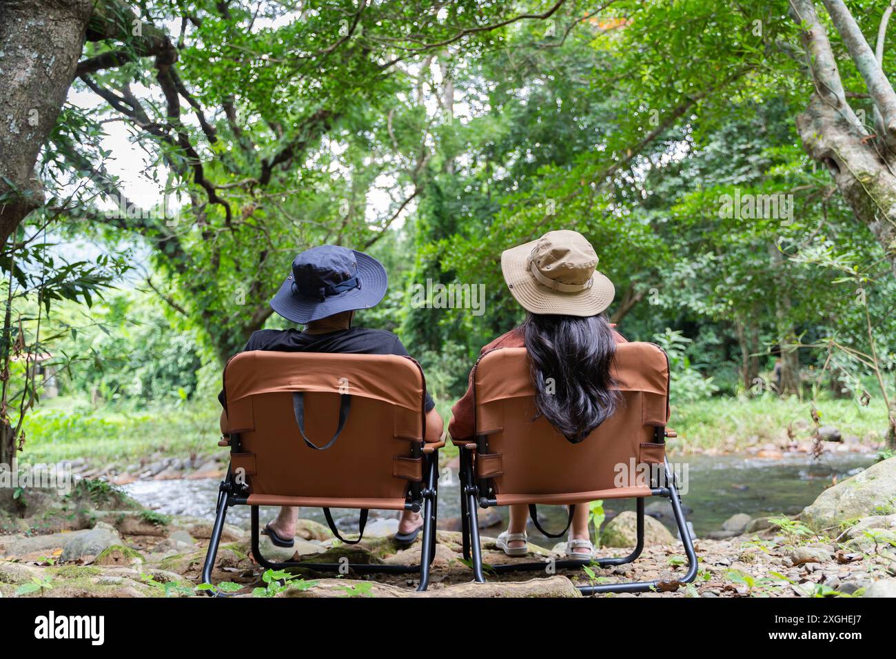 Couple sitting on a chair in a comfortable campsite or country house ...