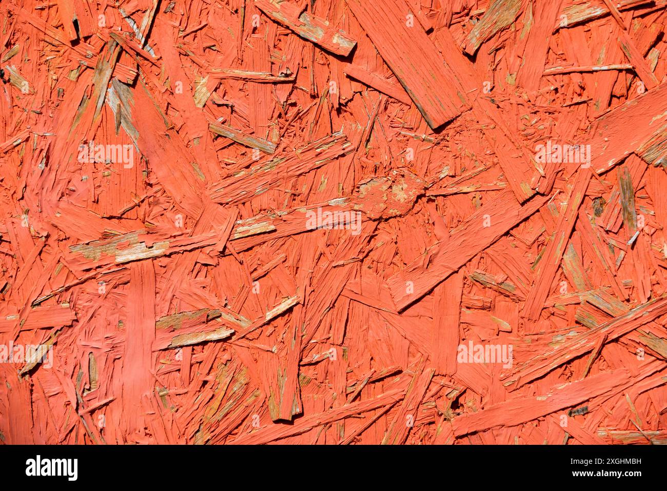 Priented strand board OSB painted in red. Sterling board background ...