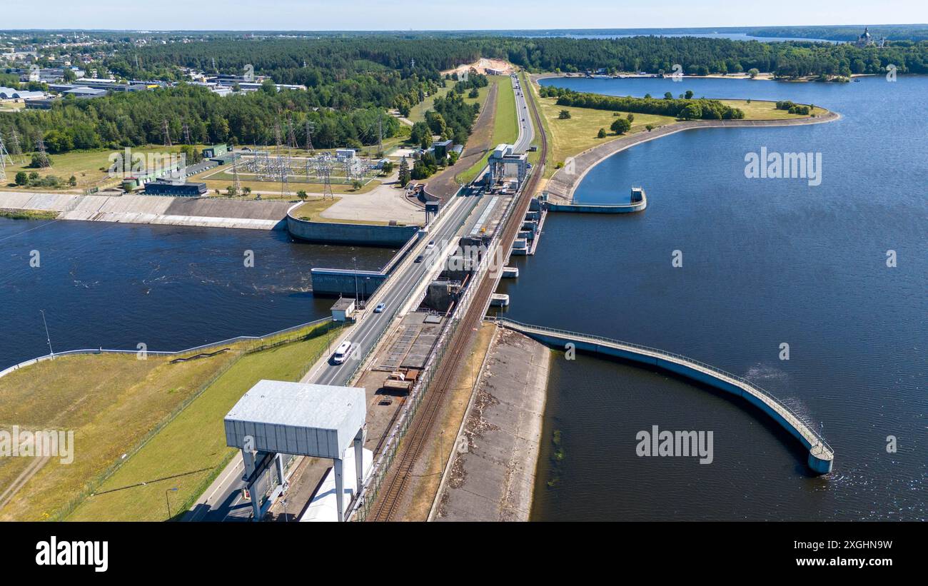 Drone photography of a hydro dam, forest and road with traffic driving ...