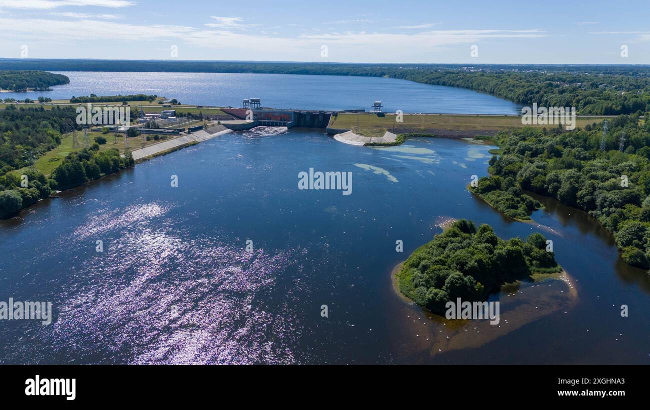Drone photography of a hydro dam, forest and road with traffic driving ...