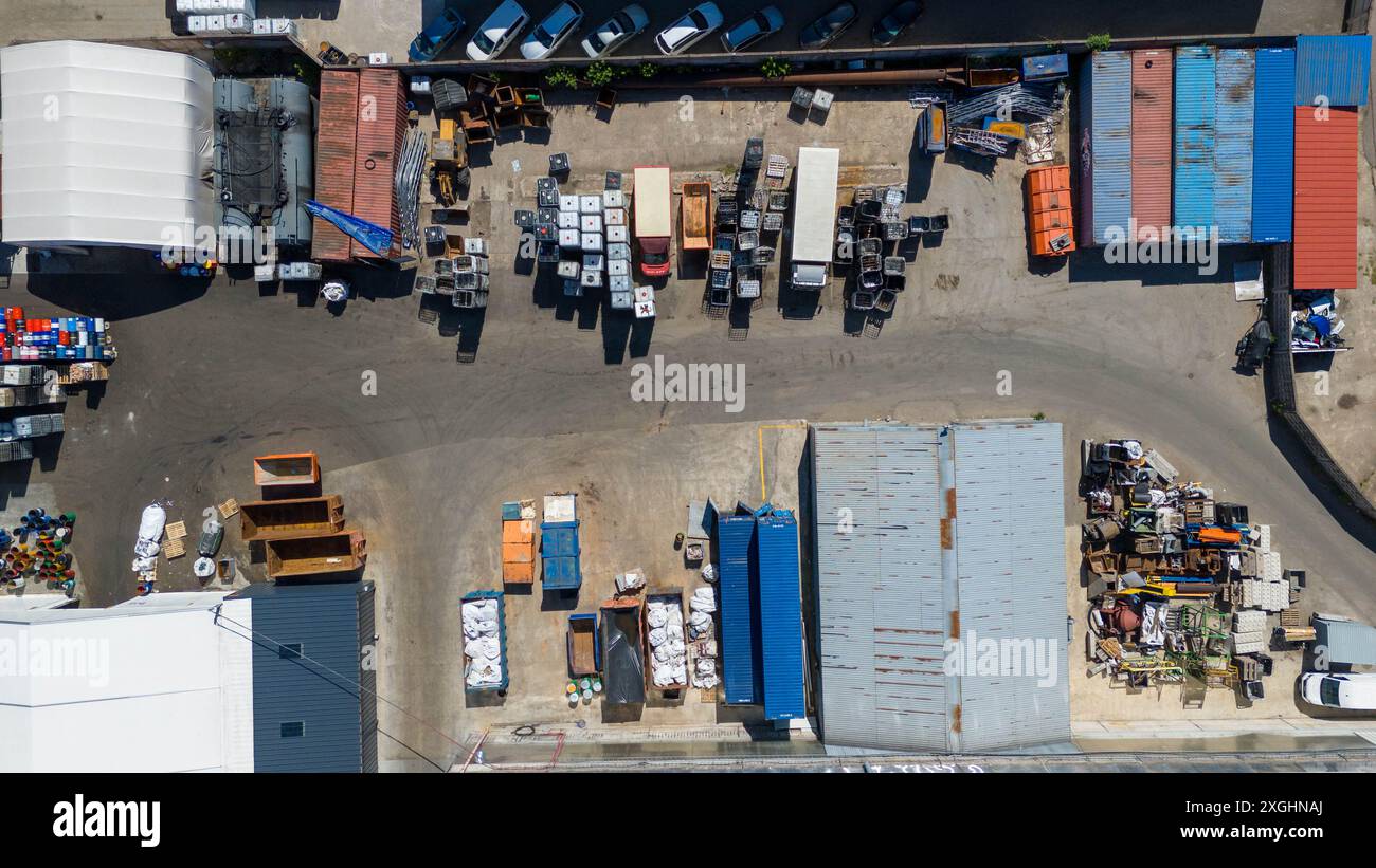 Drone photography of industrial warehouse and logistic vehicles parked ...