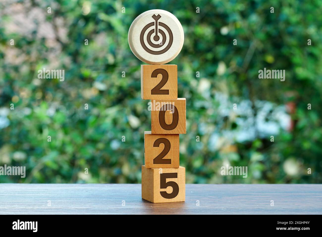 stack of wooden blocks with the year 2025 engraved and a target sign at ...
