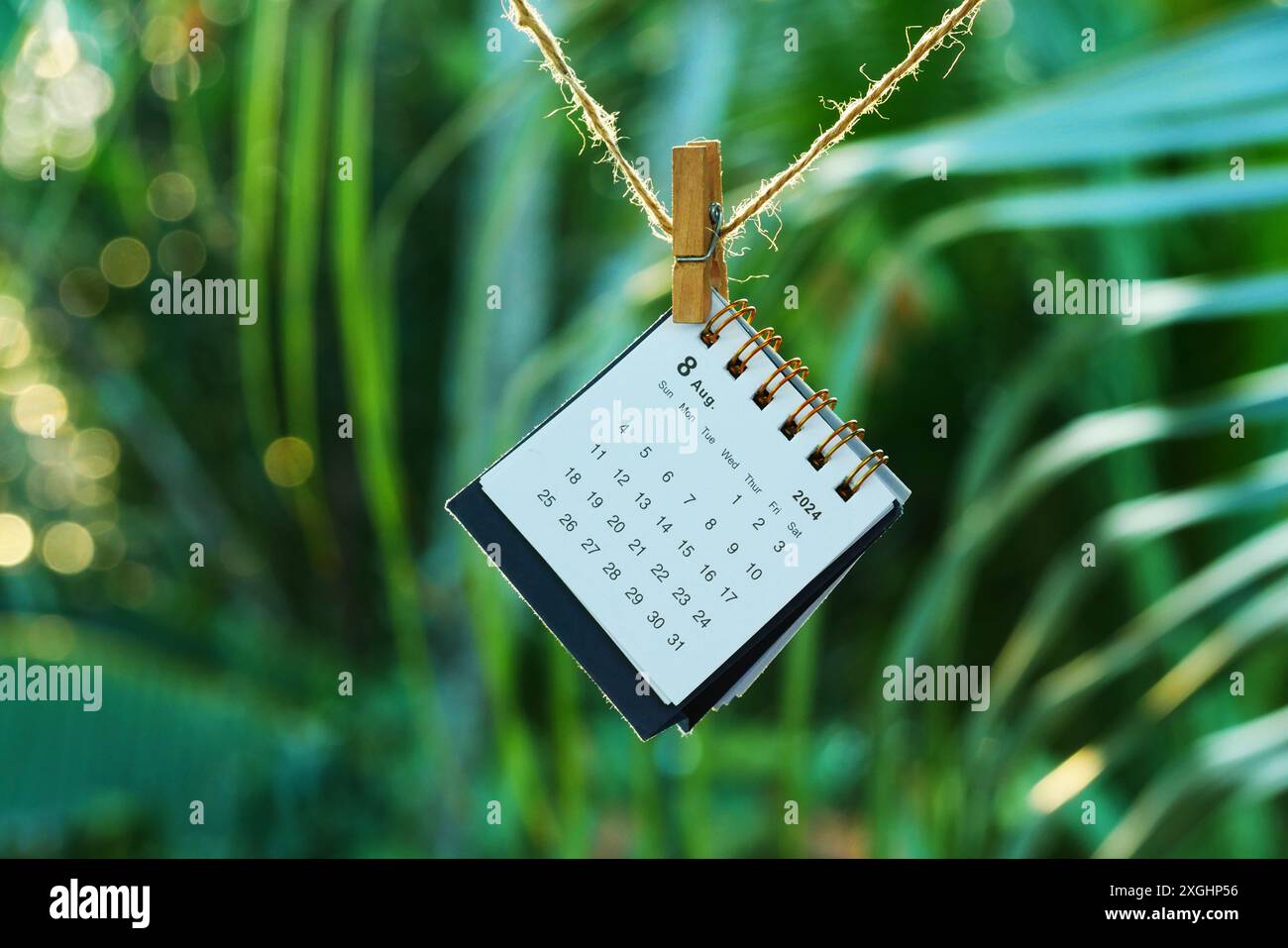 August 2024 calendar on rope with bokeh sunset nature background Stock ...