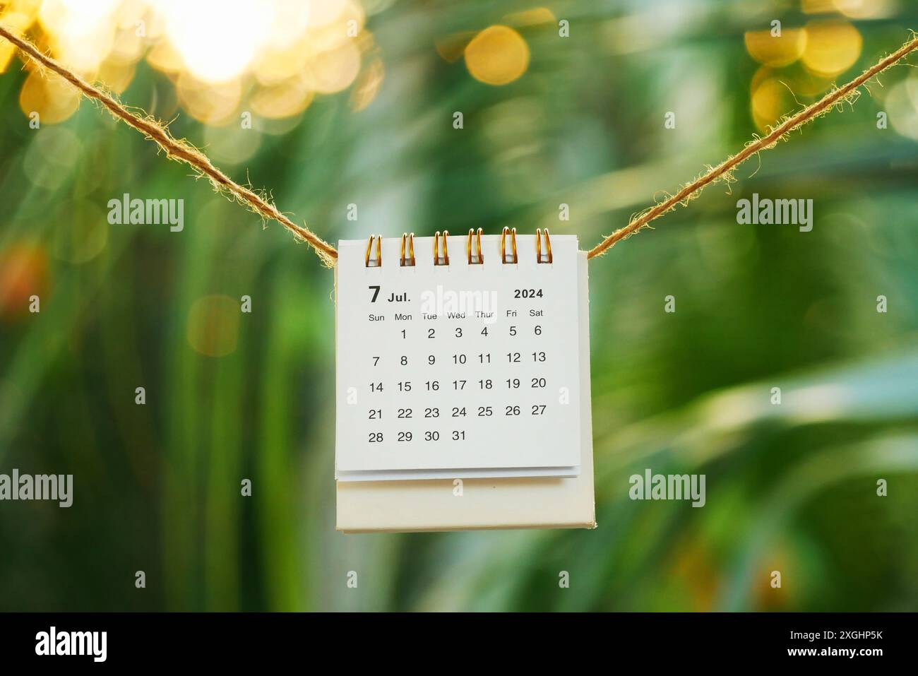 July 2024 calendar on rope with bokeh sunset nature background Stock ...