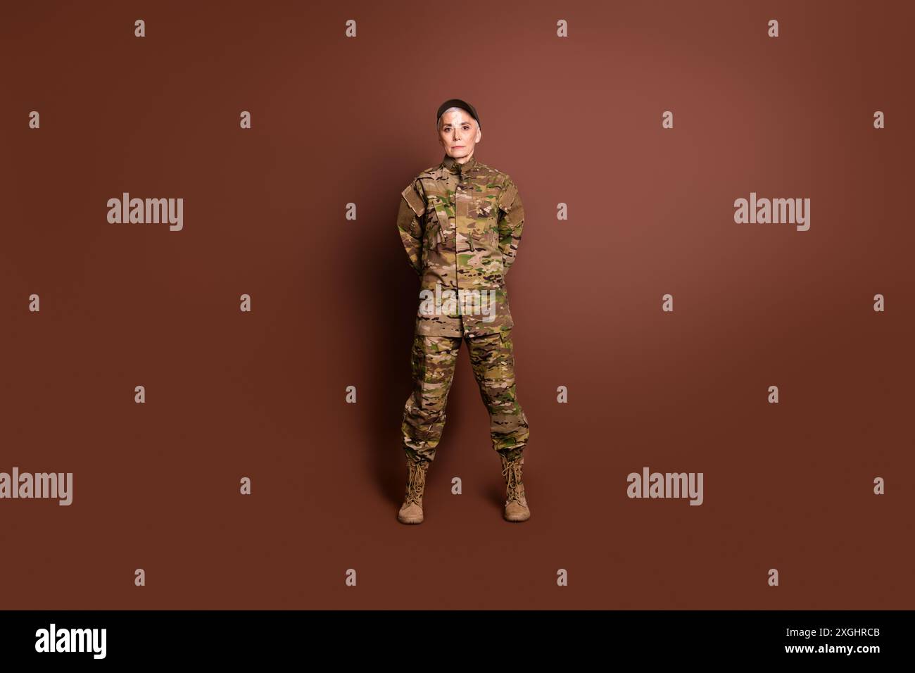 Full size photo of senior female servicewoman stand hands behind back ...