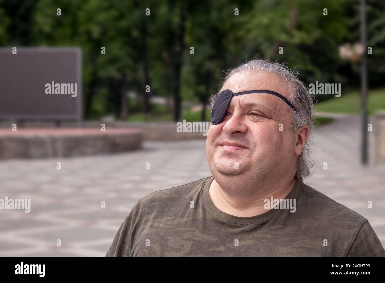 Portrait of a blind, visually impaired man with a black medical bandage ...