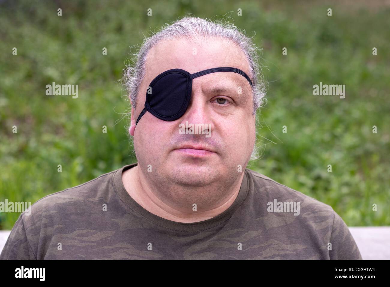Close-up portrait of a blind, visually impaired man with a black ...