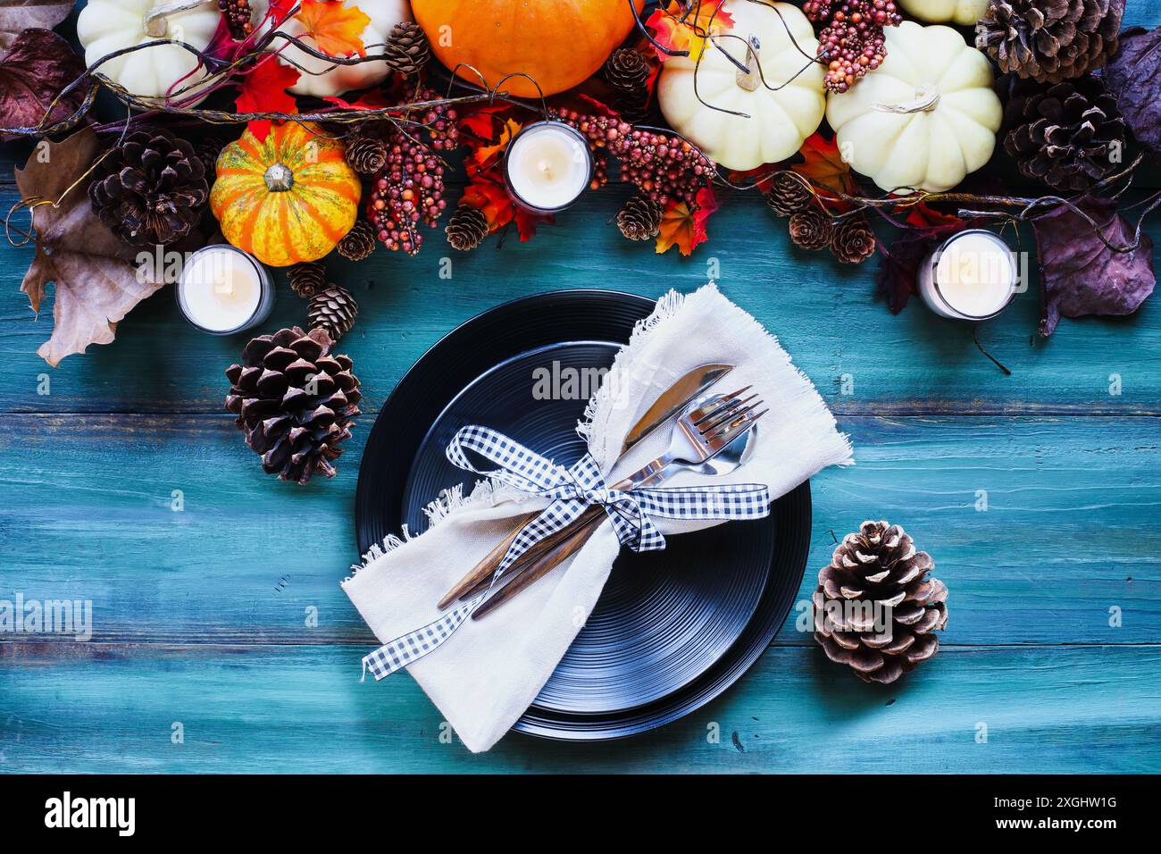 Flat lay of a black plate with napkin and silverware place setting over ... Flat lay of a black plate with napkin and silverware place setting over ...