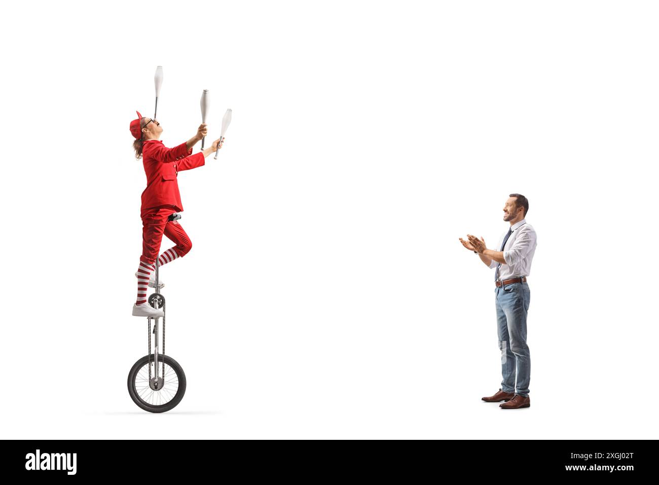 Man giving an applause and watching an acrobat riding a giraffe ...