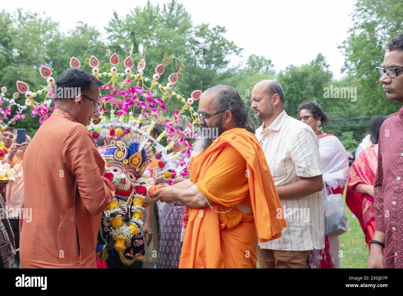 Swami Balgopal, a priest & monk, carries a statue of the Hindu god ...