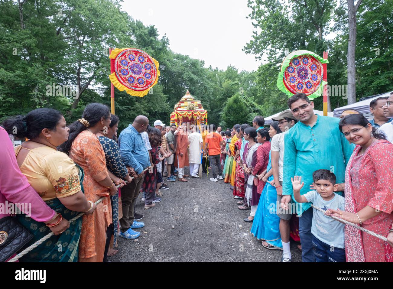 At the 2024 Ratha Yatra, proud Hindu parents and their shy young son ...
