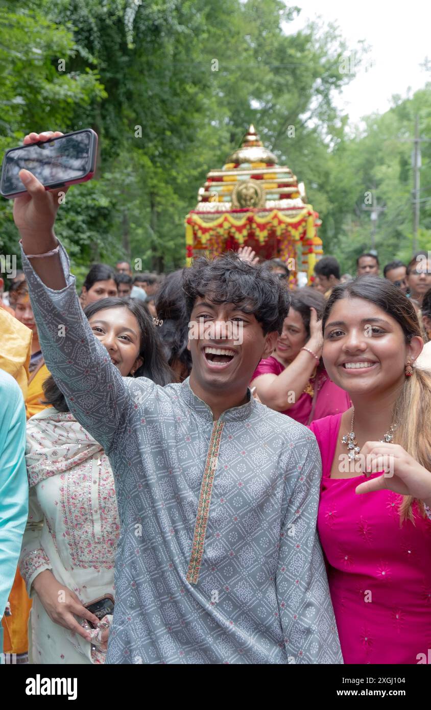 A happy young man takes a selfie of himself, his lady companion and the ...